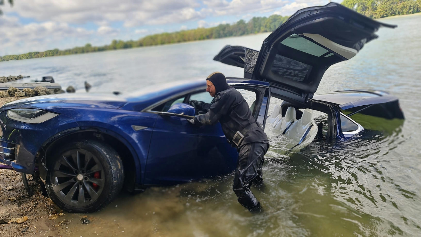 Dramatic photos show Tesla pulled from river